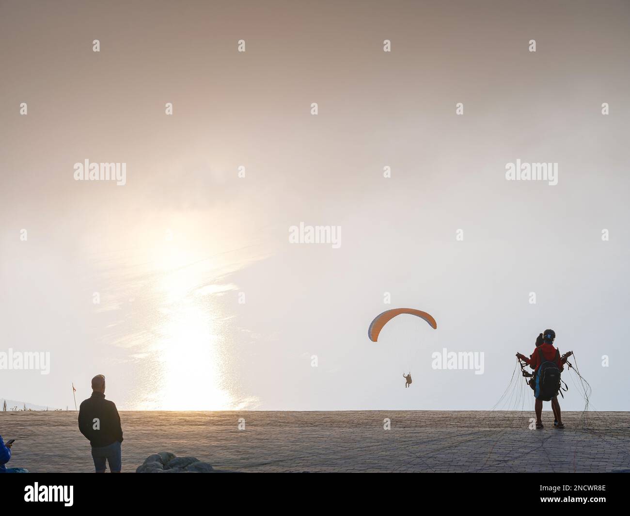 Paragliding in sky. Paraglider tandem flying over sea and mountains in ...