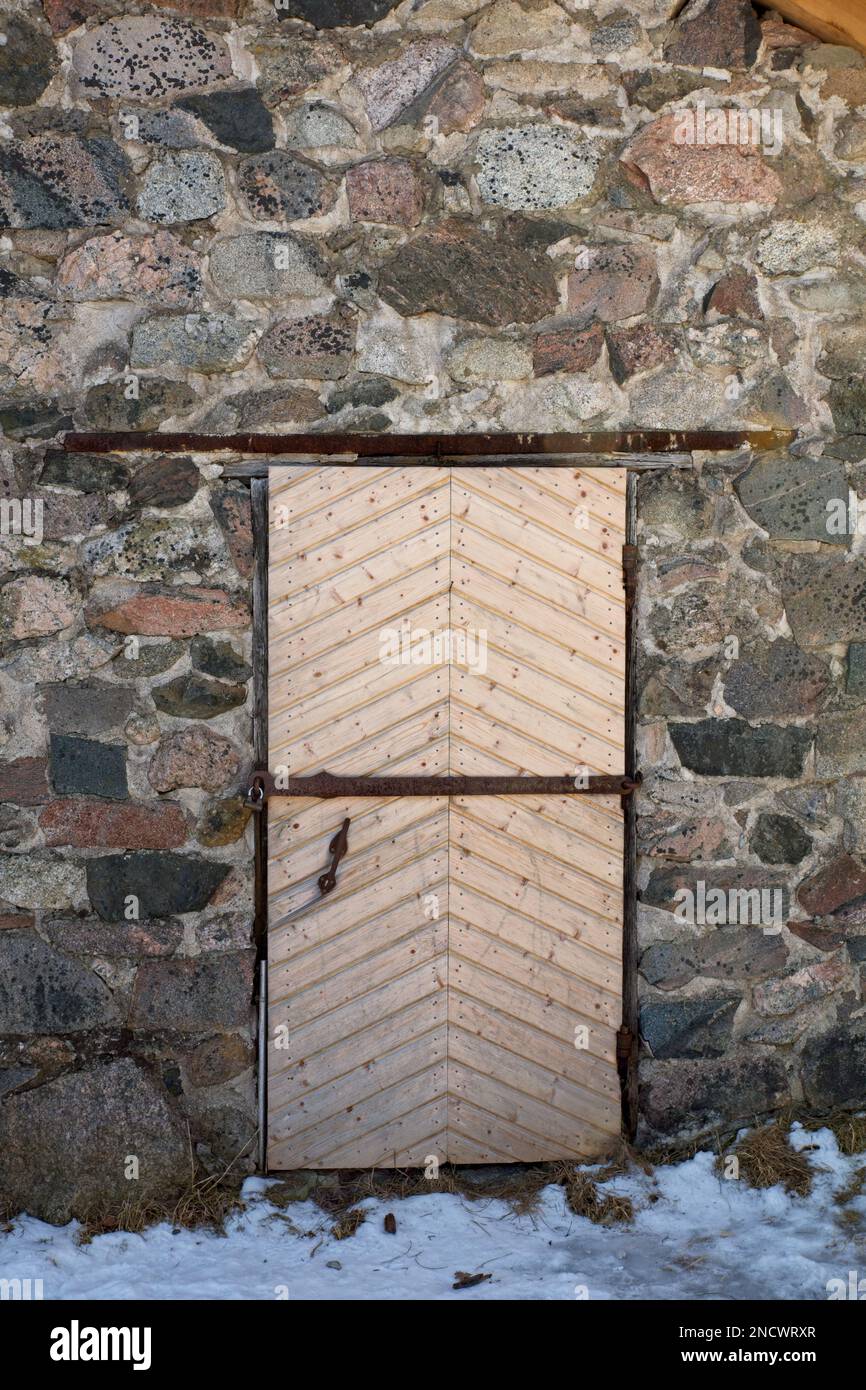Wooden door barred on an old stone building Stock Photo - Alamy