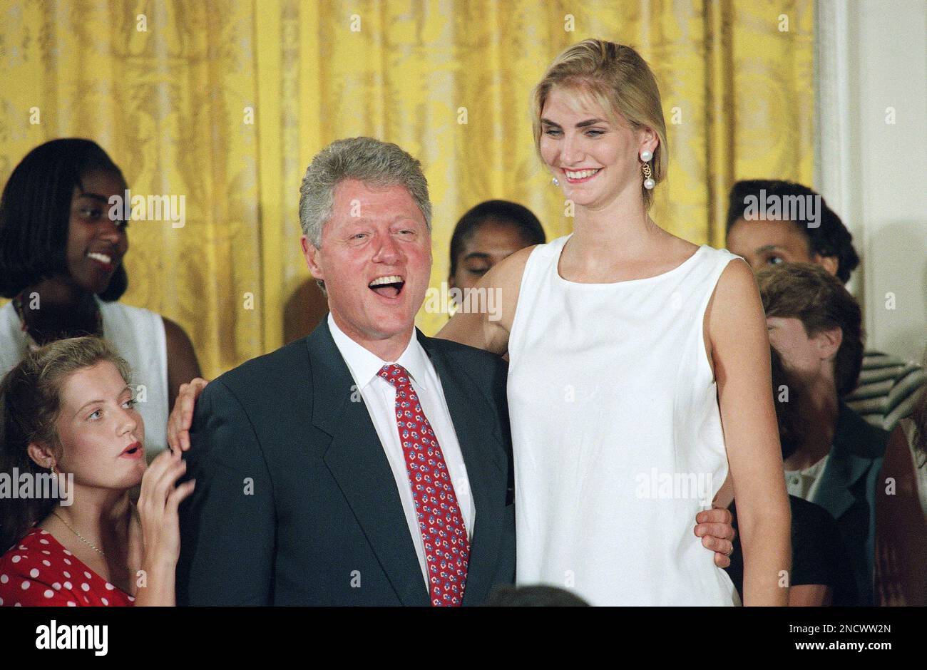 President Bill Clinton poses with six-foot, seven-inch Gwendolyn ...