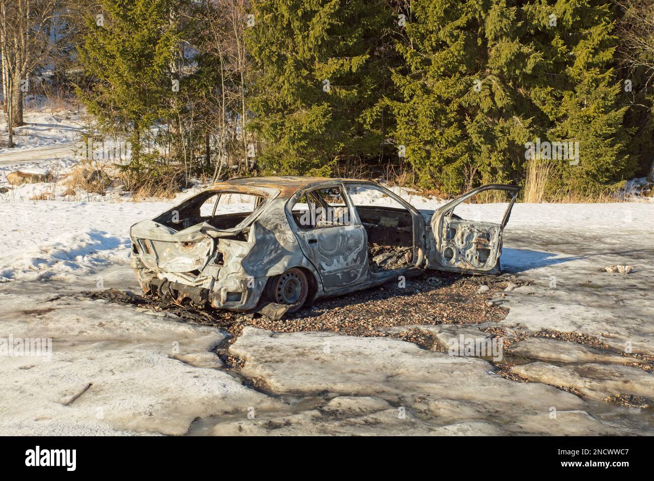 Wrecked abandoned burnt car with fire damage on the side of road Stock ...