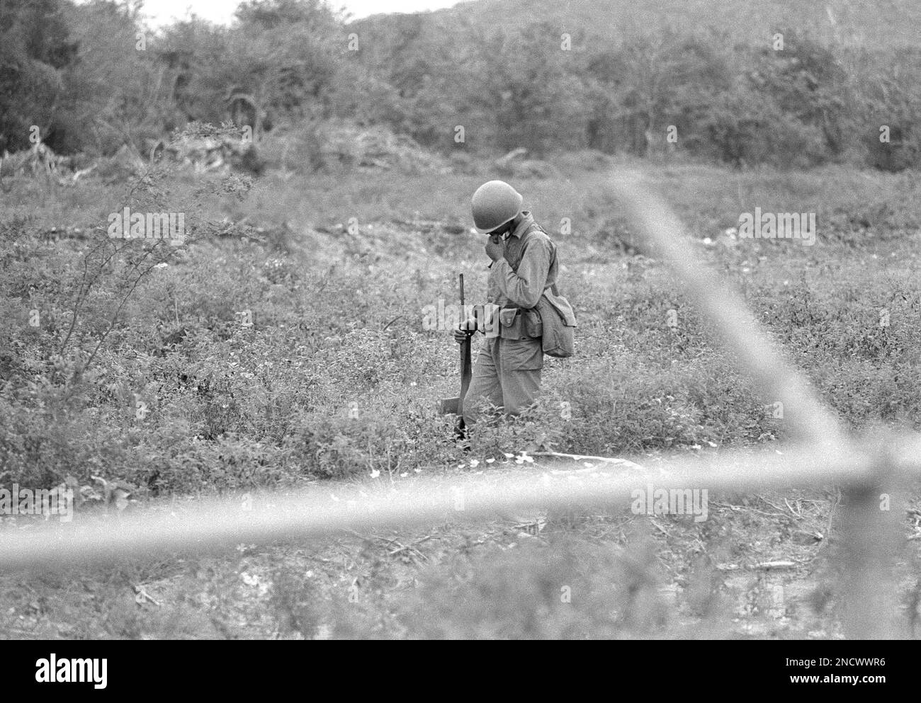 A Cuban soldier patrols Cuban territory outside the fence of the U.S ...