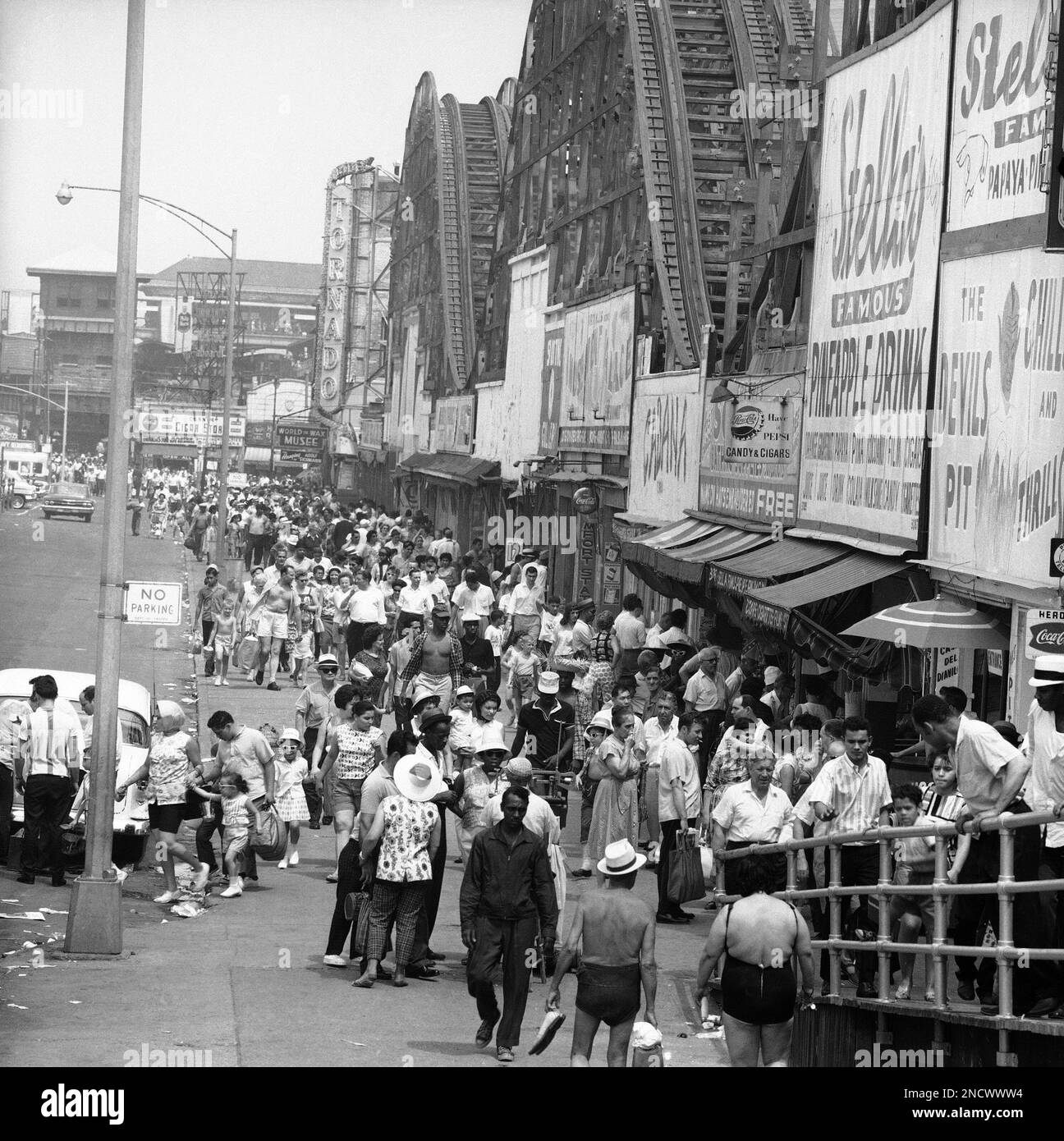 Mobs of people disgorge from the Surf Ave. subway station at Coney ...