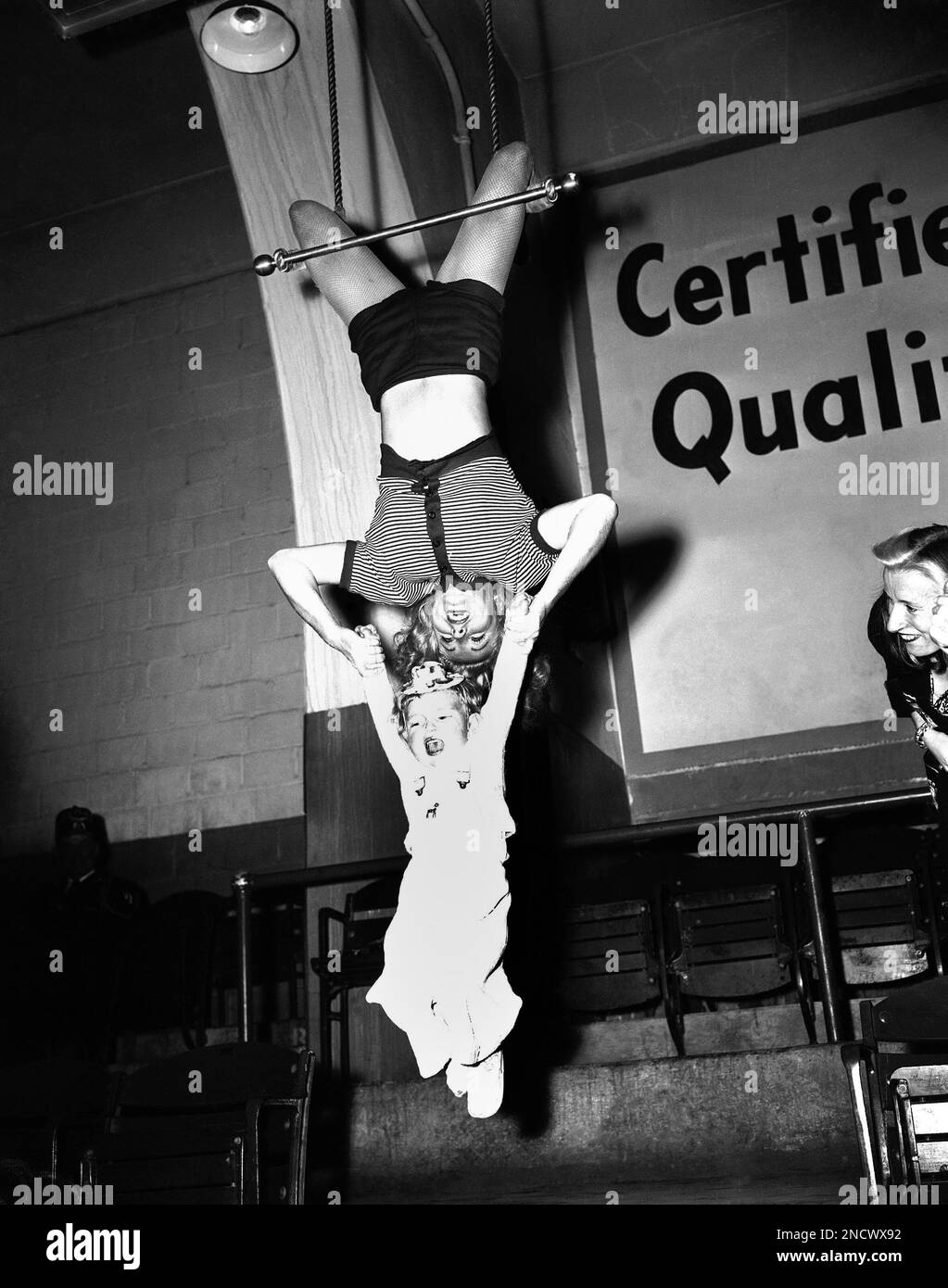 Victoria George, of Atlanta, Ga., swings little Danielle Olson, age 2, of Mexico, during a ...