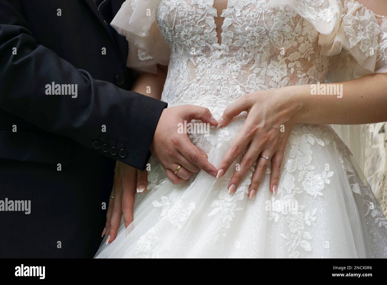 A married couple forming a shape of a heart with their hands Stock ...