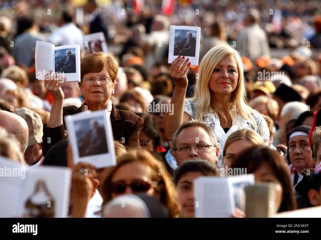 Faithful hold portraits of Canadian Brother Andre Bessette, during a a ...