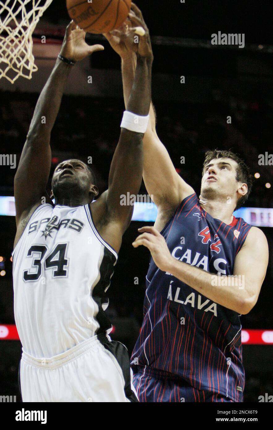 Caja Laboral's Stanko Barac, right, of Croatia, shoots over San Antonio ...