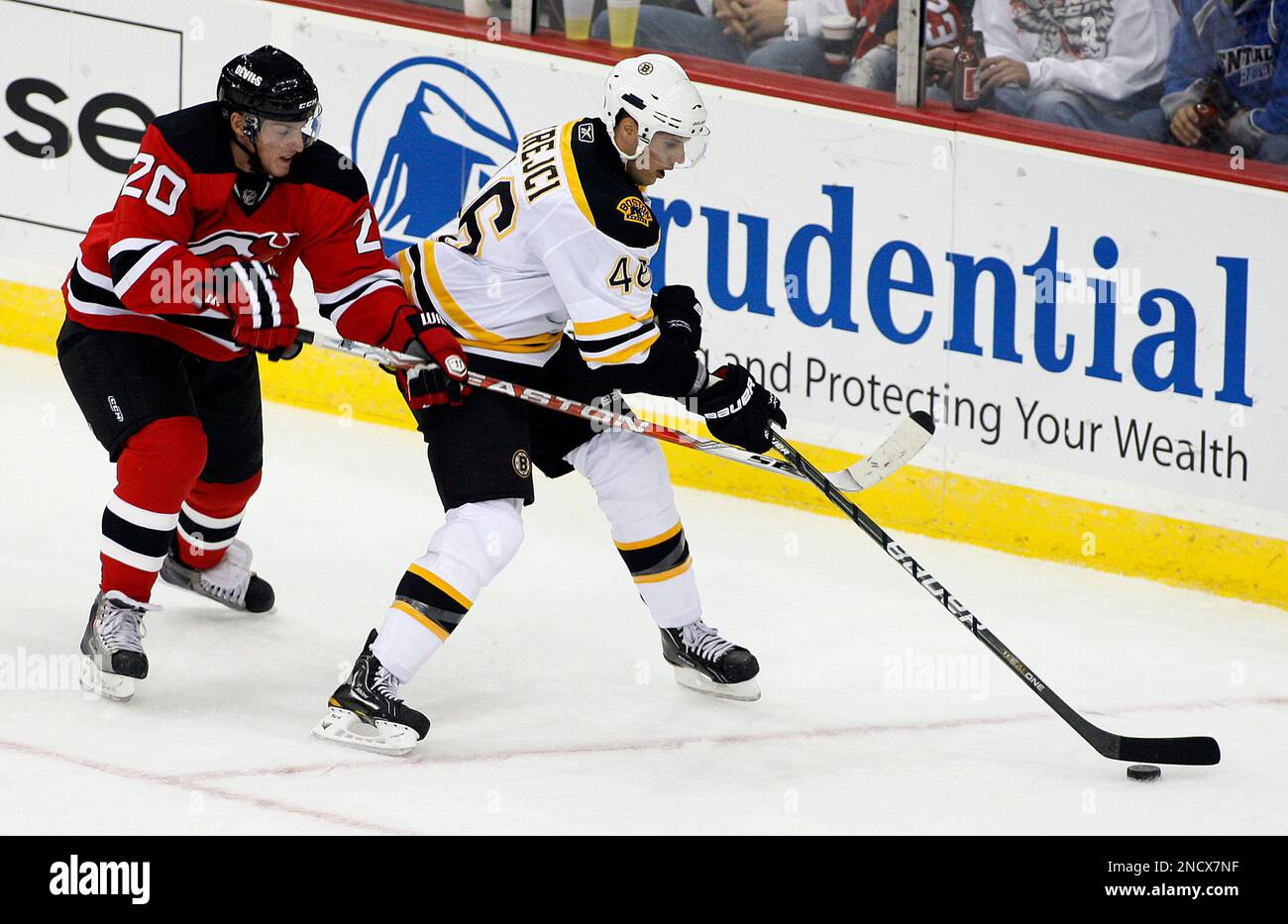 New Jersey Devils' Matt Taormina (20) tries to get the puck away from ...