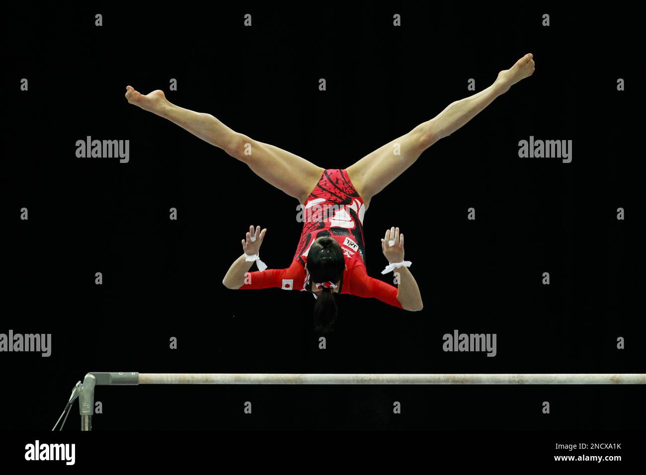 Yuko Shintake of Japan performs on the uneven bars during the women's ...
