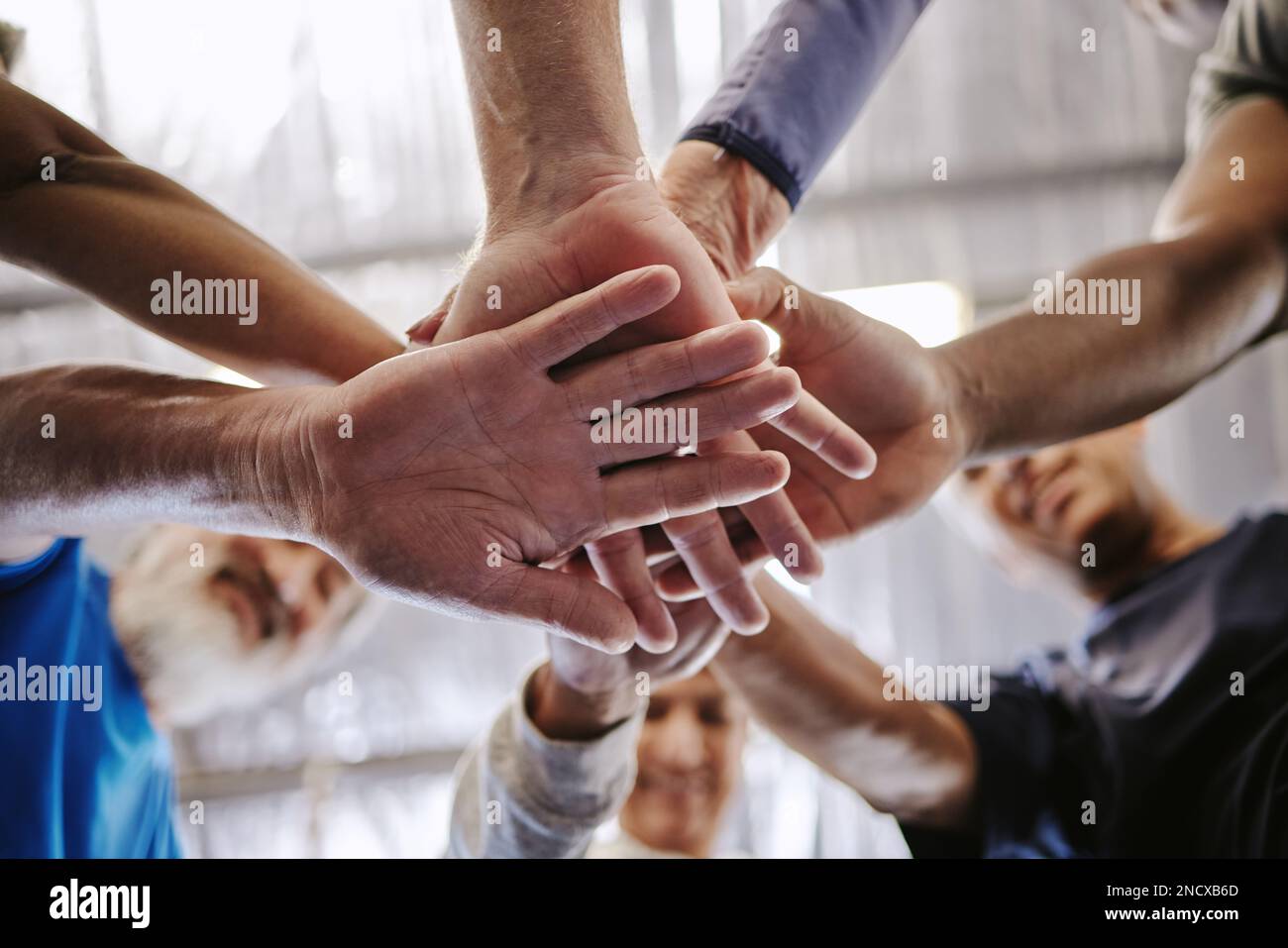 Teamwork, hands together and low angle of people in gym for motivation, solidarity and team ...