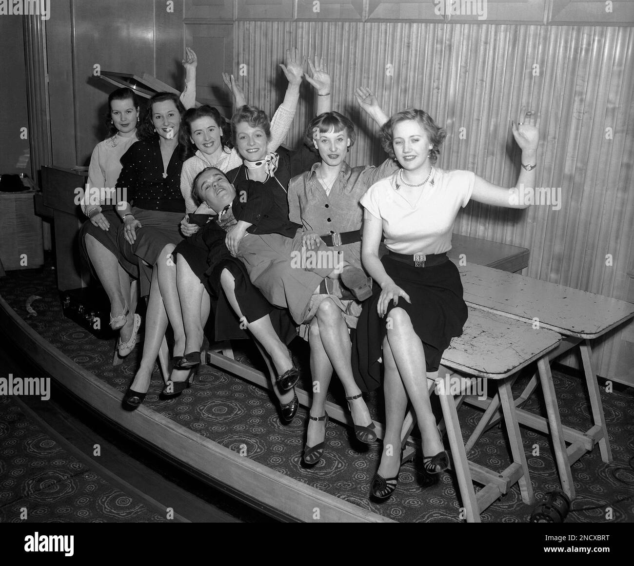 Midget clown Harry Berman takes it easy as he arrives on the liner ...