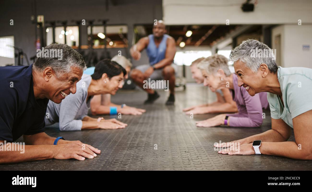 Senior People Fitness And Plank With Personal Trainer In Class For