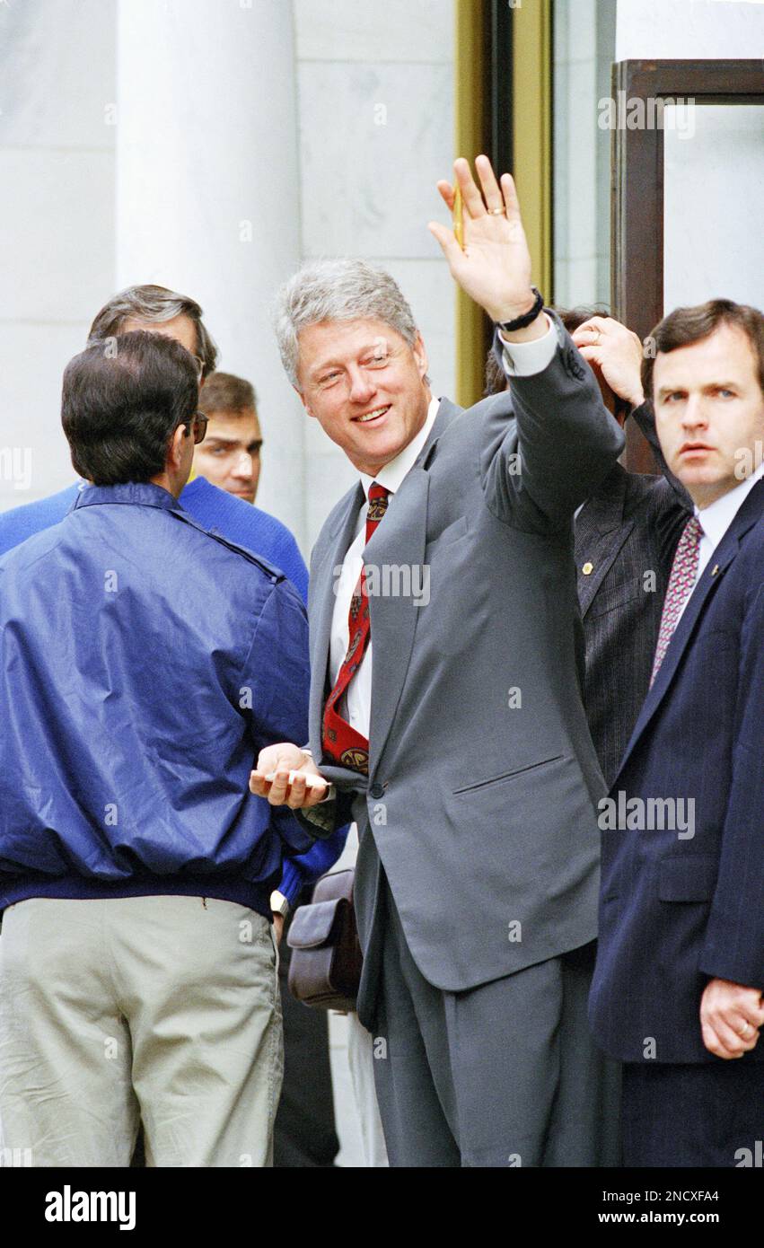 U.S. President Bill Clinton waves as he leaves the Old Ebbitt Grill in ...