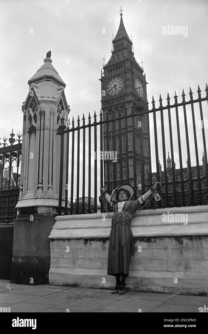 Comedian Norman Wisdom dressed as a suffragette and chained to the ...