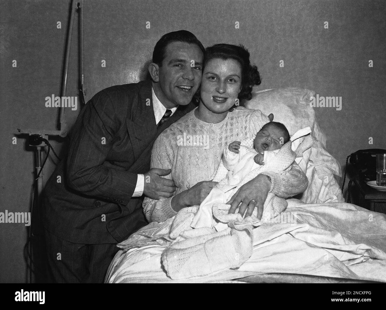Comedian Norman Wisdom poses with wife Freda and their new born ...