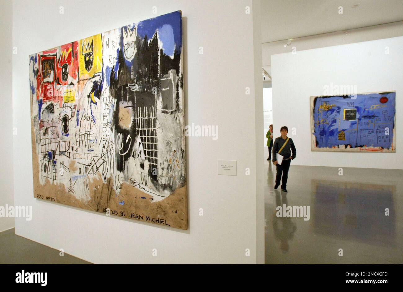 A member of the medias walks past: "Crowns (Peso Neto)", left, and ...