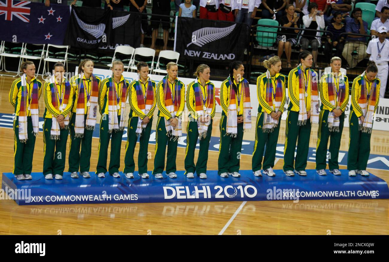 Silver winning Australian netball team members stand on the podium with ...