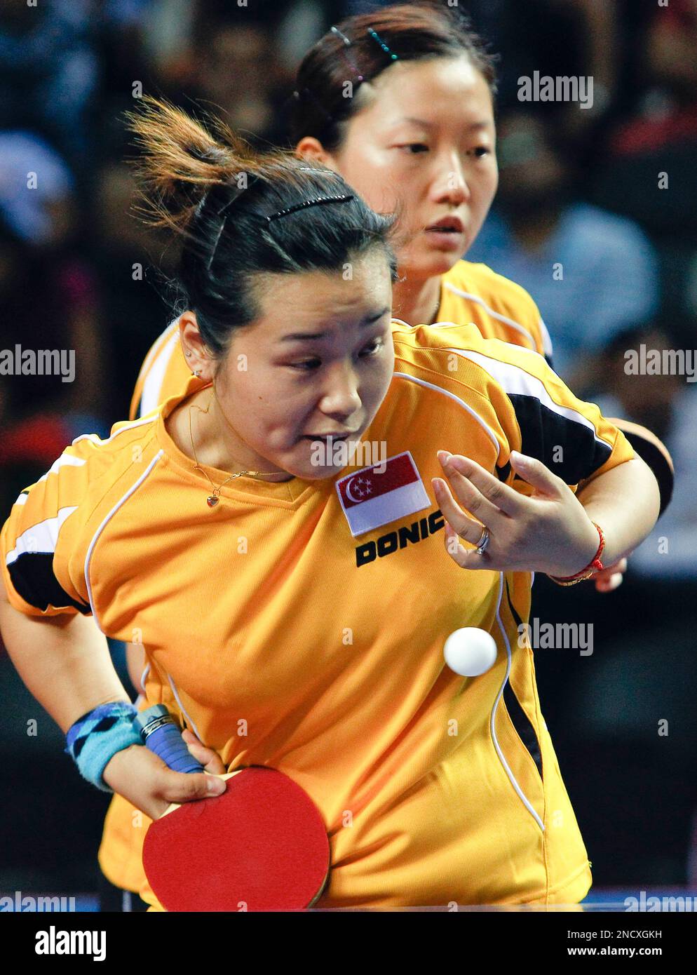 Singapore's Sun Beibei, backed by teammate Li Jaiwei, right, serves a ...