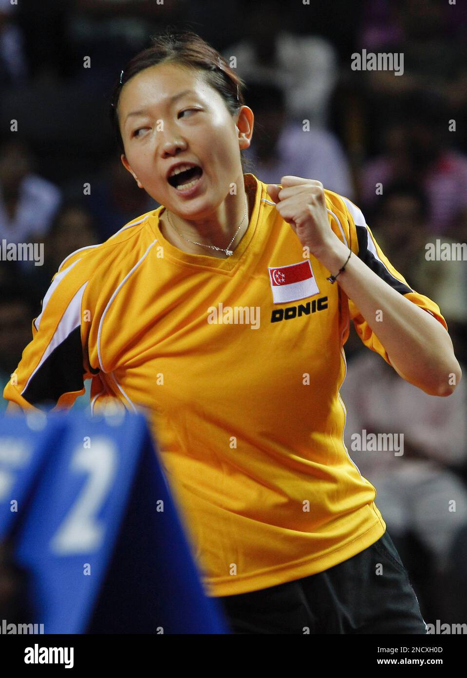 Singapore's Li Jiawei reacts after winnig a point in the women's double table tennis final for ...