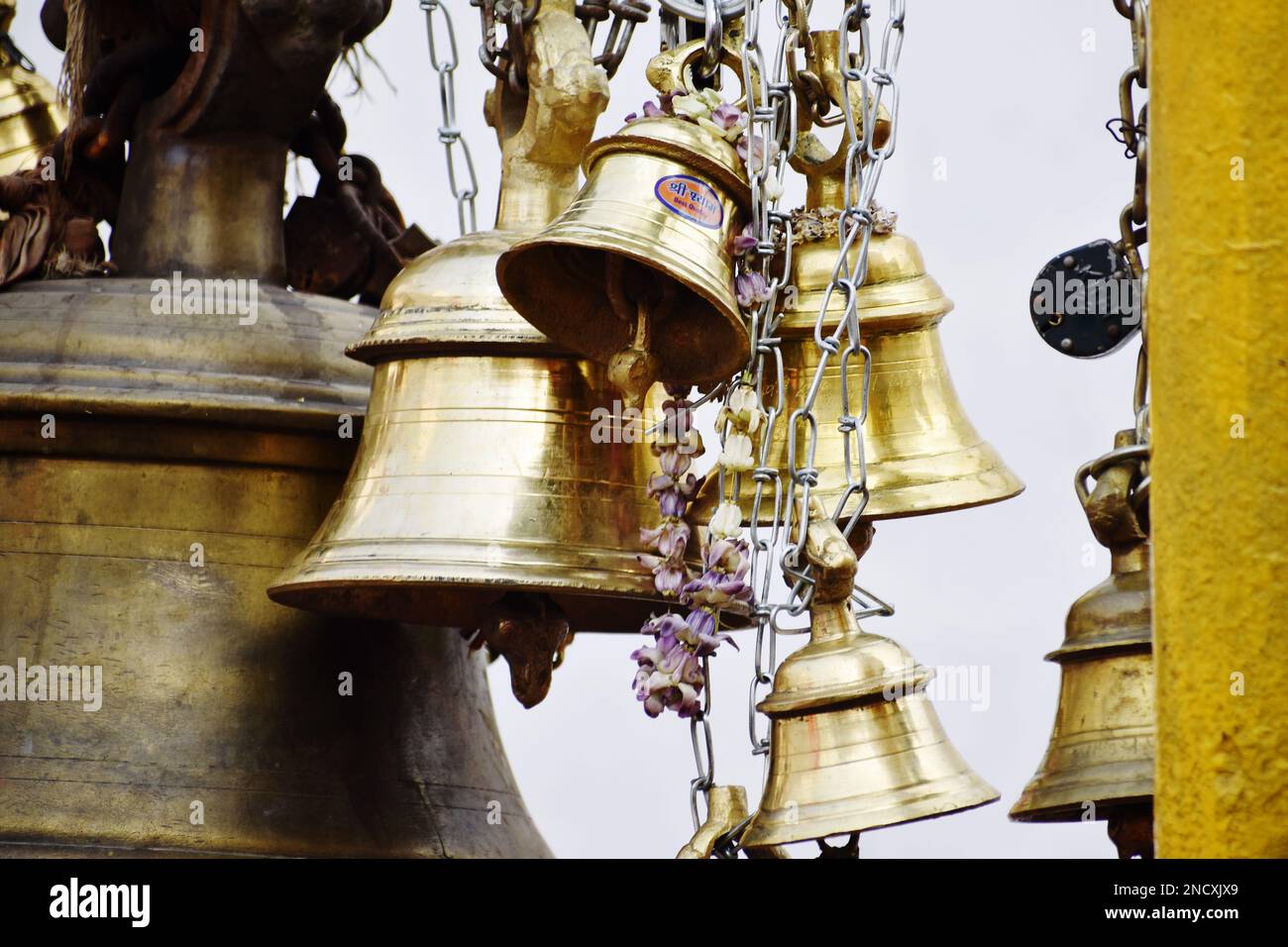 Metal bells hanging at the entrance of a temple Stock Photo - Alamy