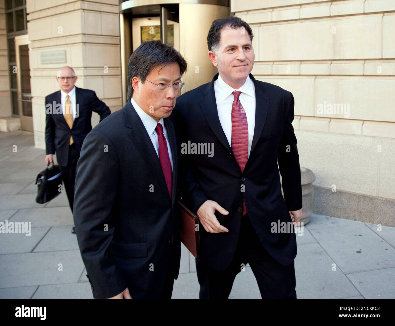 Dell CEO Michael Dell, right, leaves federal court in Washington ...