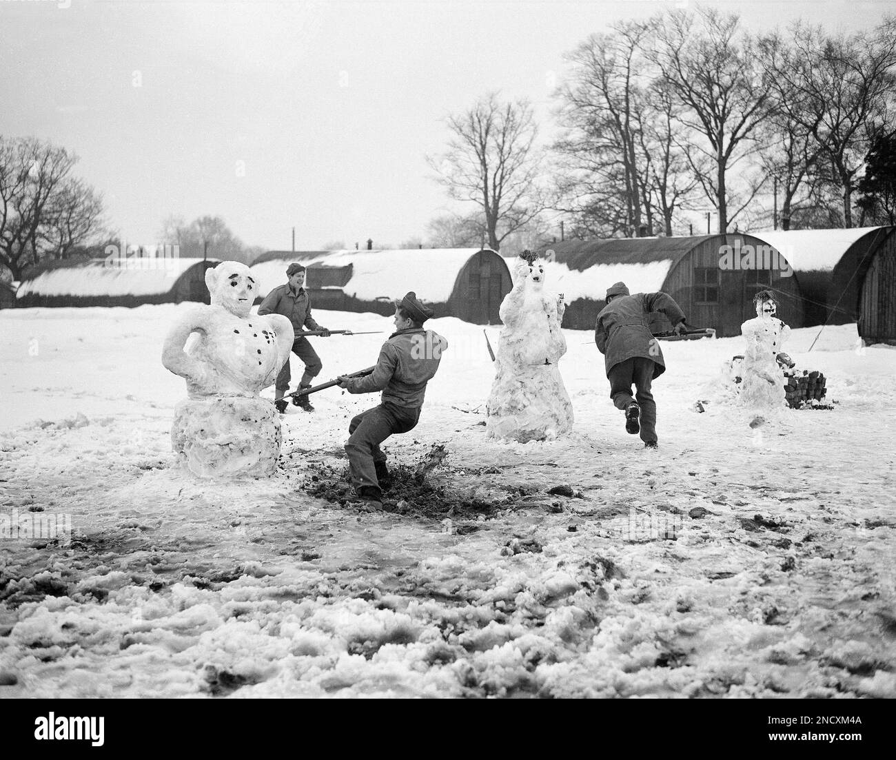 U.S. Army troopers at their base in Northern Ireland, use snowmen built ...