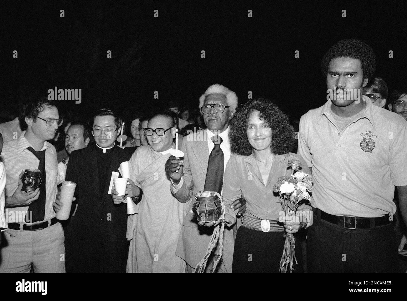 Singer Joan Baez walks with a group of people including civil rights ...