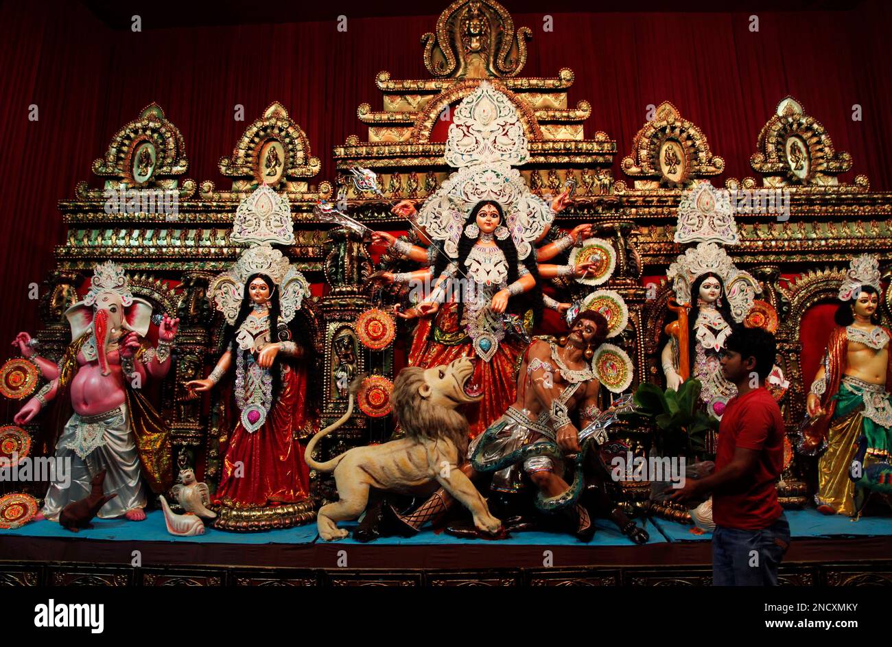 Hindu devotees performs rituals inside a "pandal," during the Durga ...