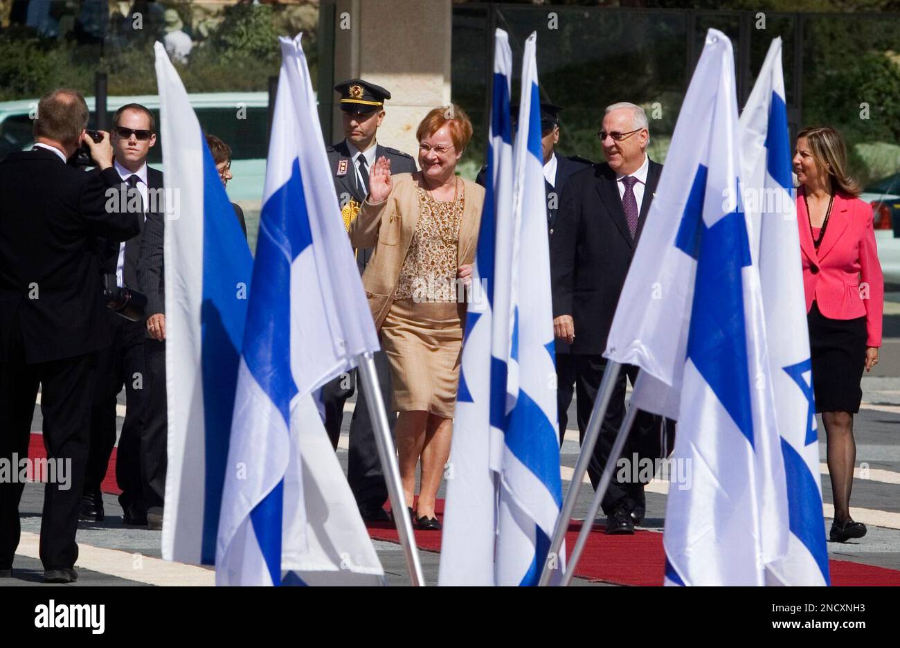 Finnish President Tarja Halonen, background, left, walks next to ...