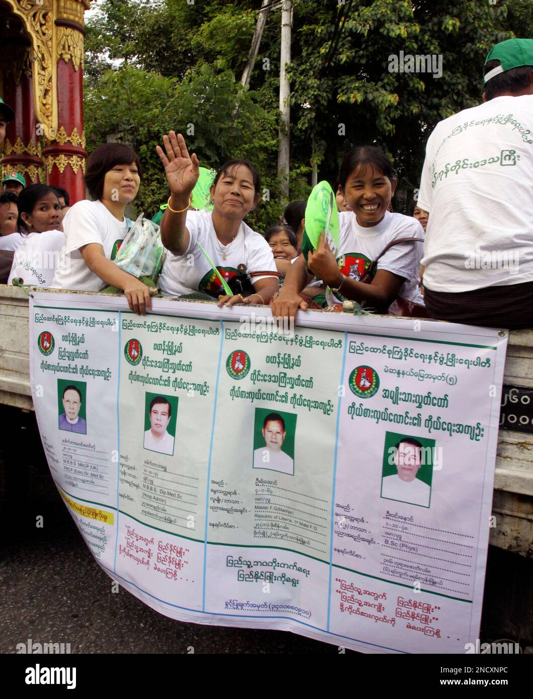 Members of the Union Solidarity and Development Party (USDP) wave hands ...