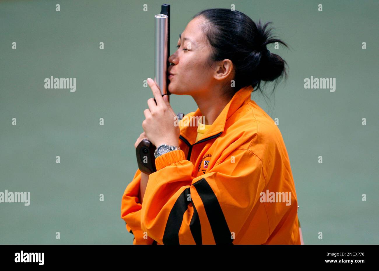 Malaysia's Ng Pei Chin Bibiana kisses her pistol after winning the gold ...