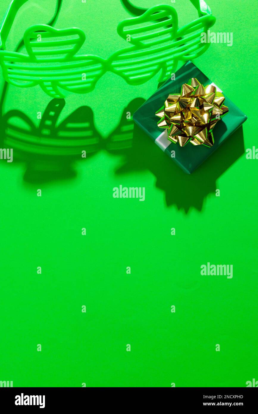 Image of green clover glasses with green present and copy space on ...