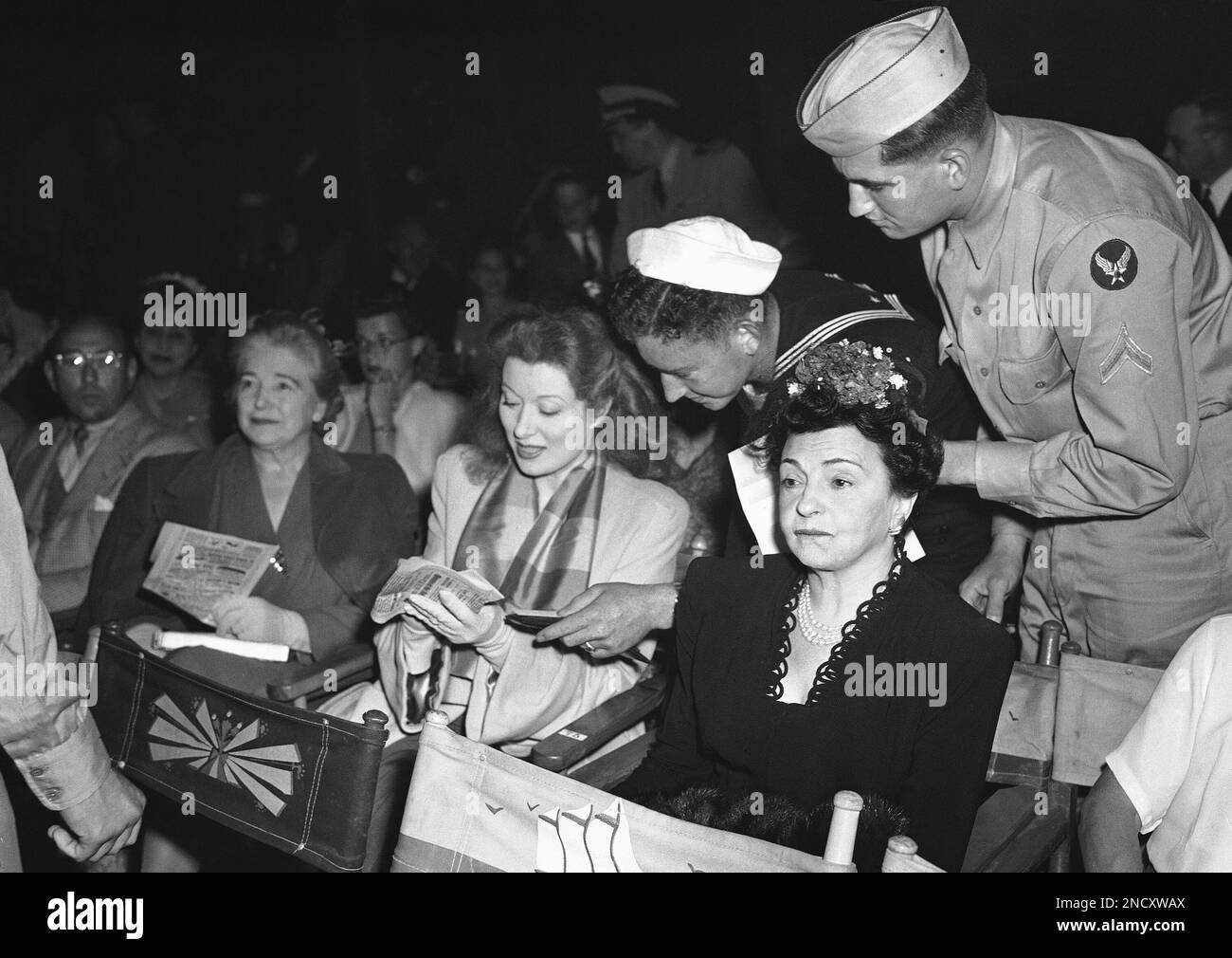 Service men keep Greer Garson, film star, pushing the autograph pencil ...