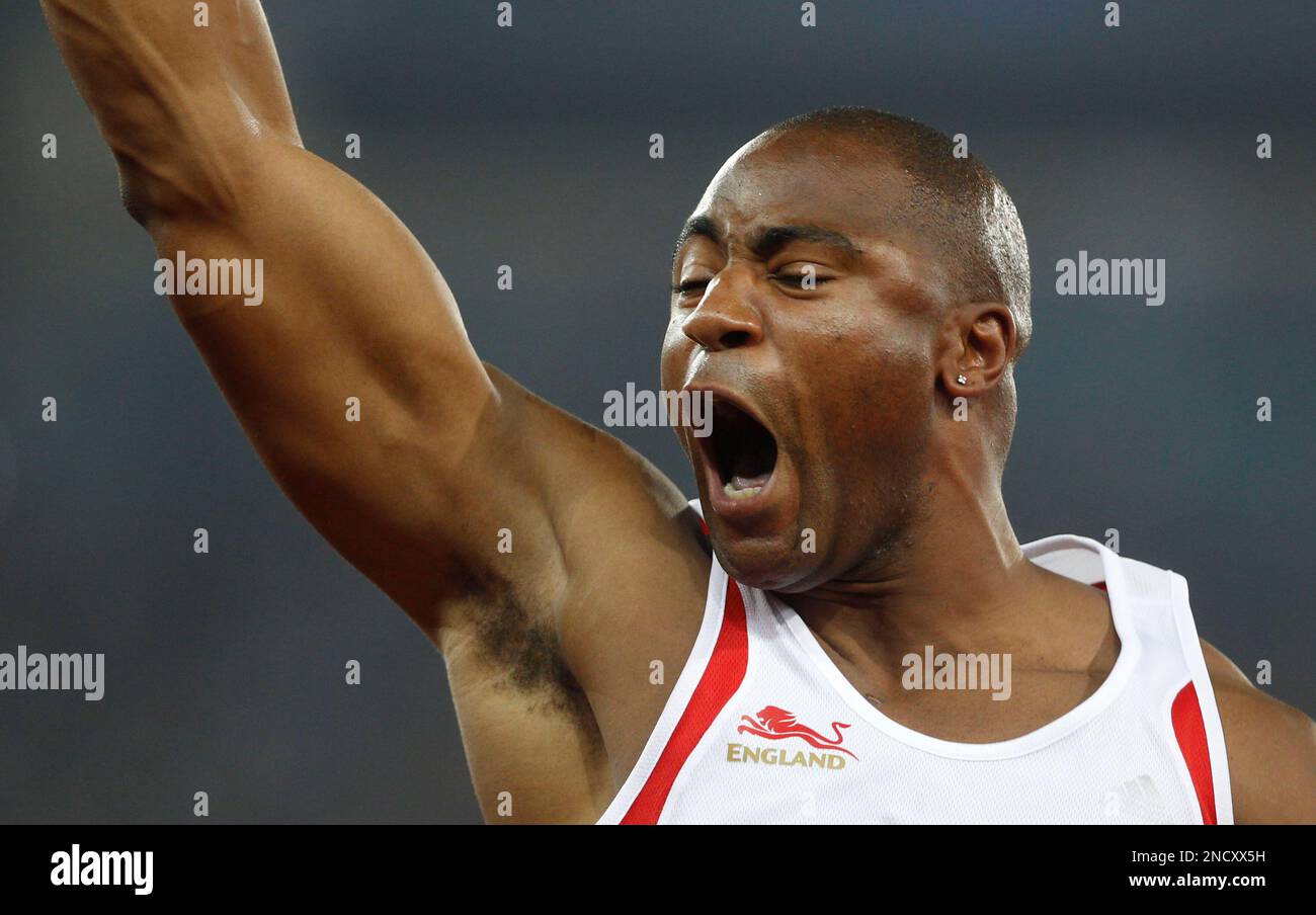 England's Mark Lewis-Francis reacts after crossing the finish line in ...