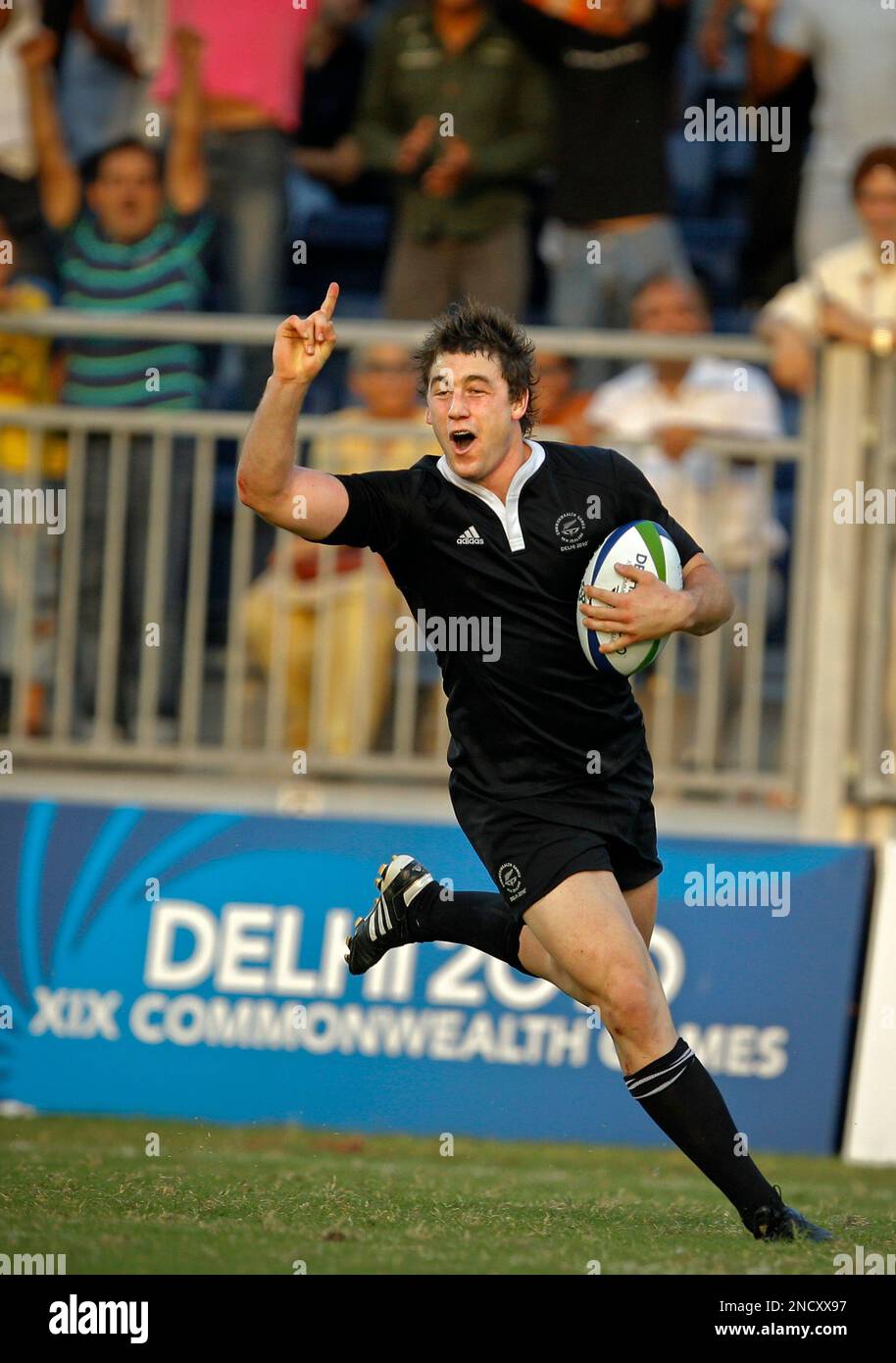 New Zealand's Kurt Baker celebrates as he runs to score the last try ...