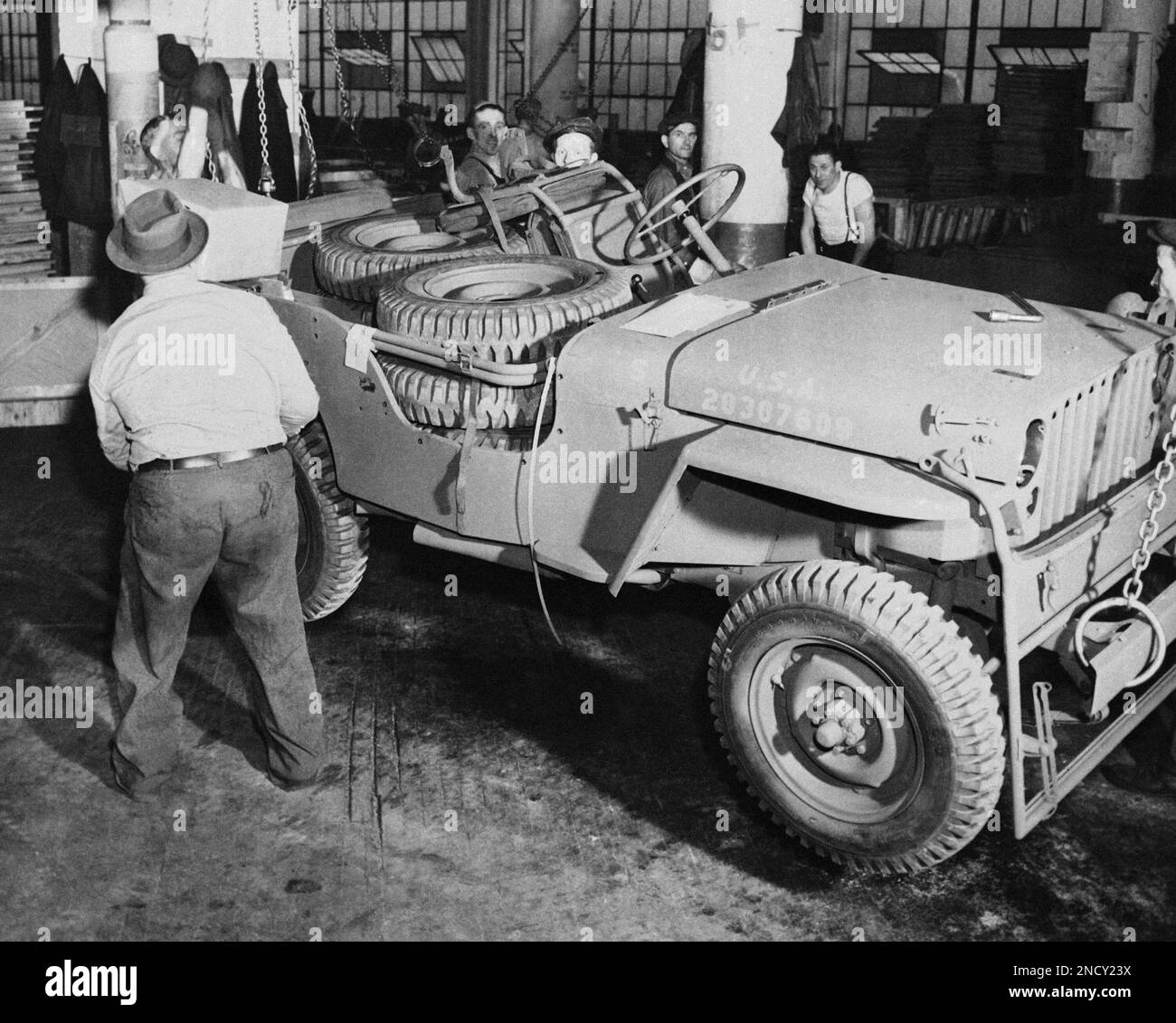 A jeep is lifted from the floor before moving to the crating line in ...