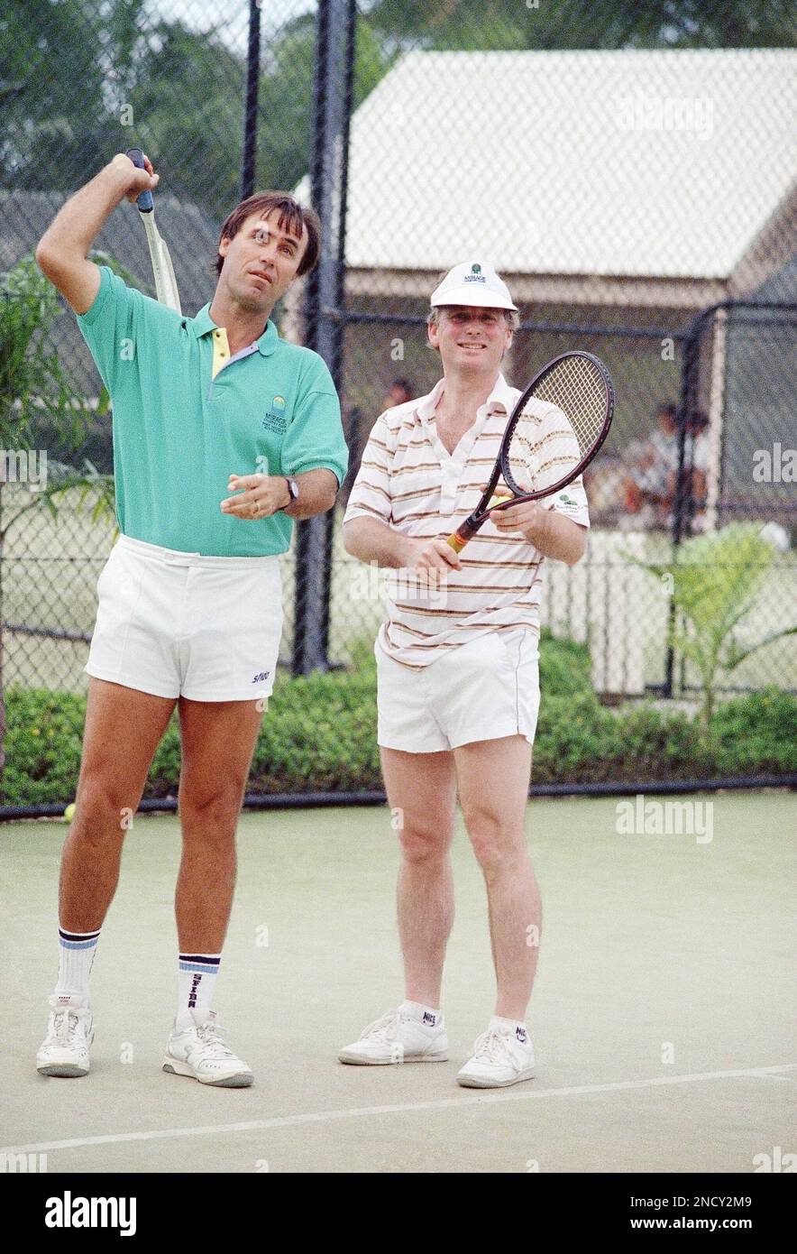 U.S. Vice President Dan Quayle gets a tennis lesson from former ...