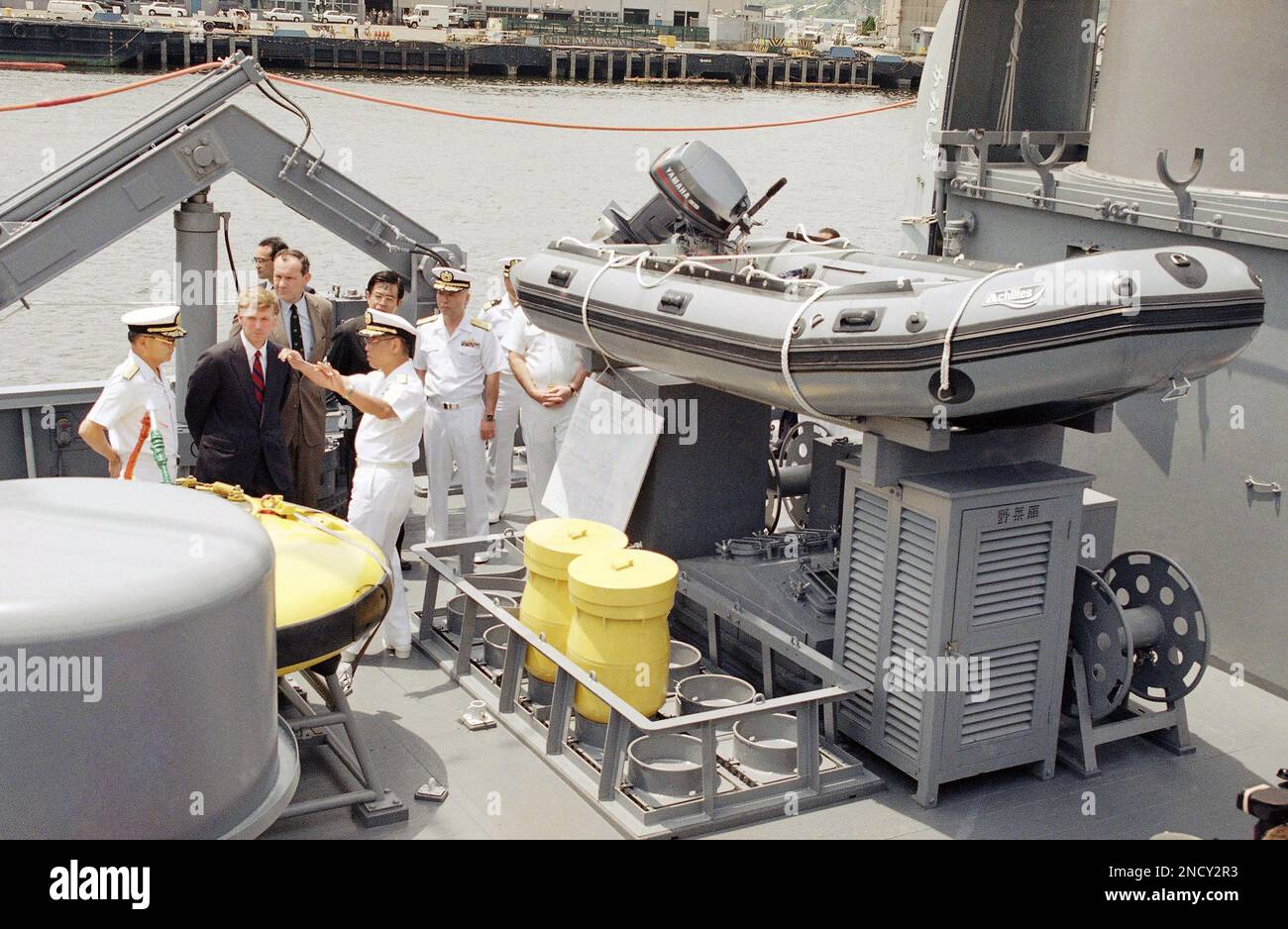 U.S. Vice President Dan Quayle is briefed by a Japanese naval officer ...
