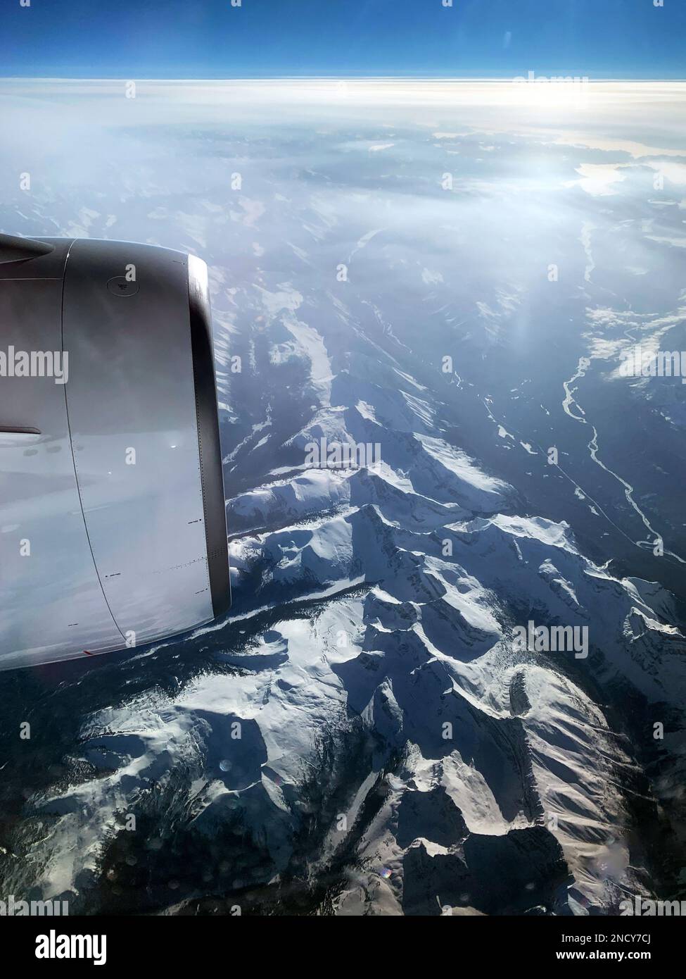 Aerial view of an aircraft engine flying over Canadian Rocky Mountains ...