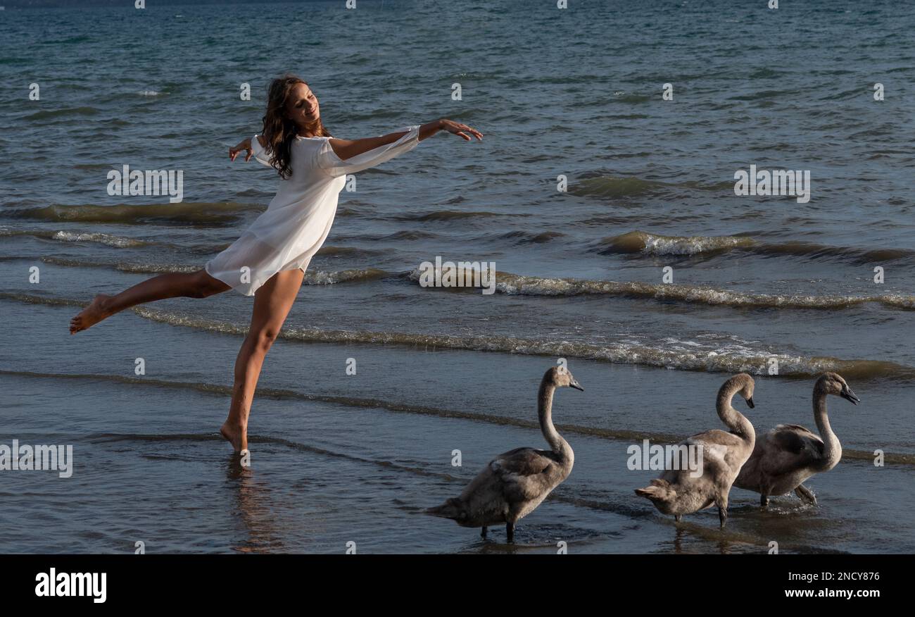Beautiful woman dancing on beach by three birds, Trevignano Romano ...