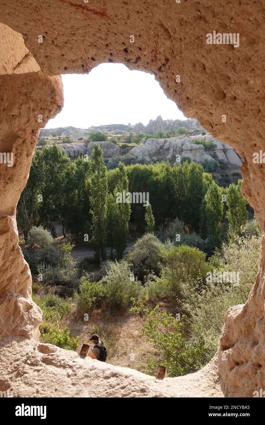 Looking outside from a hidden church carved into the rocks and hidden ...