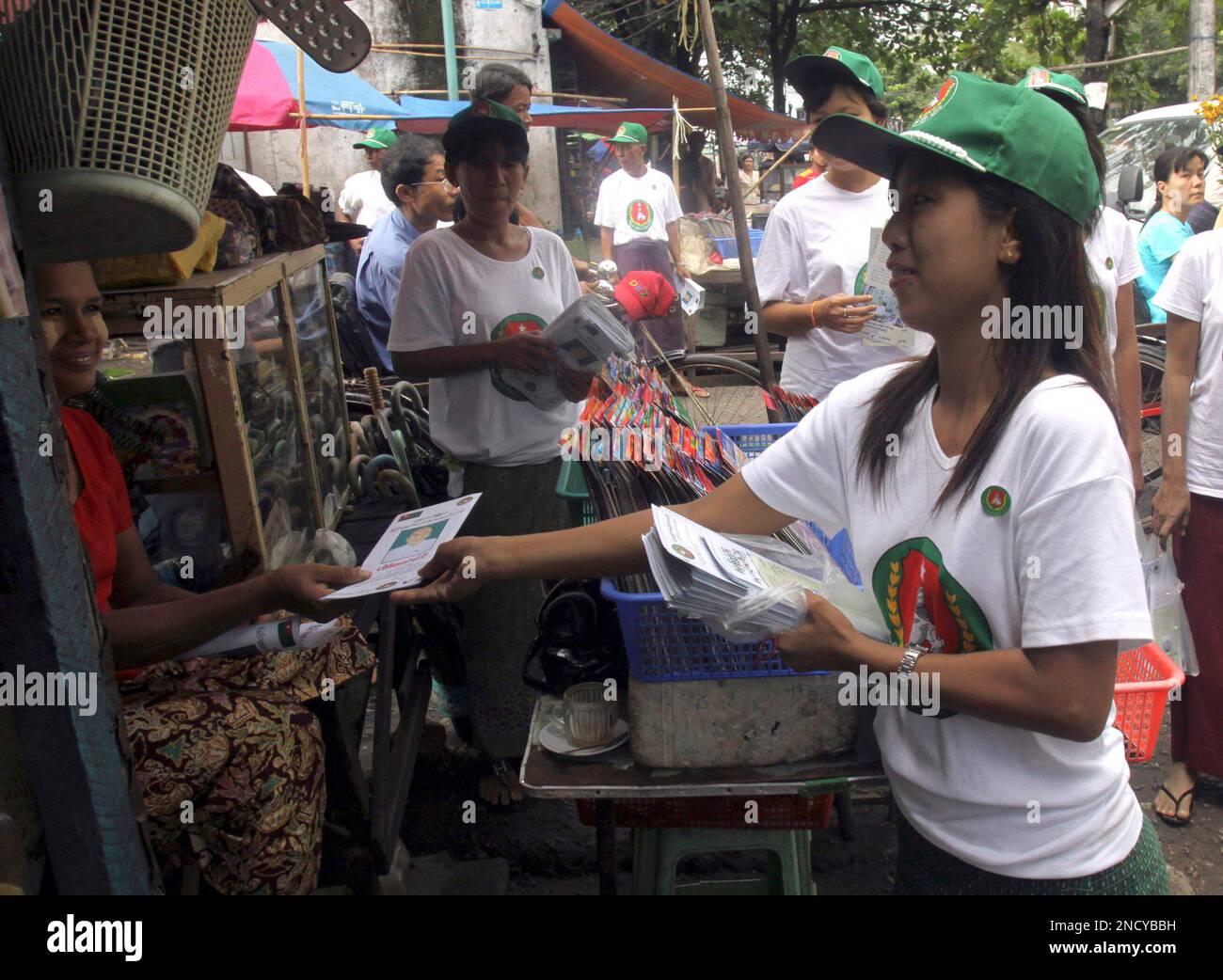 A member of Union Solidarity and Development party hands pamphlets to ...