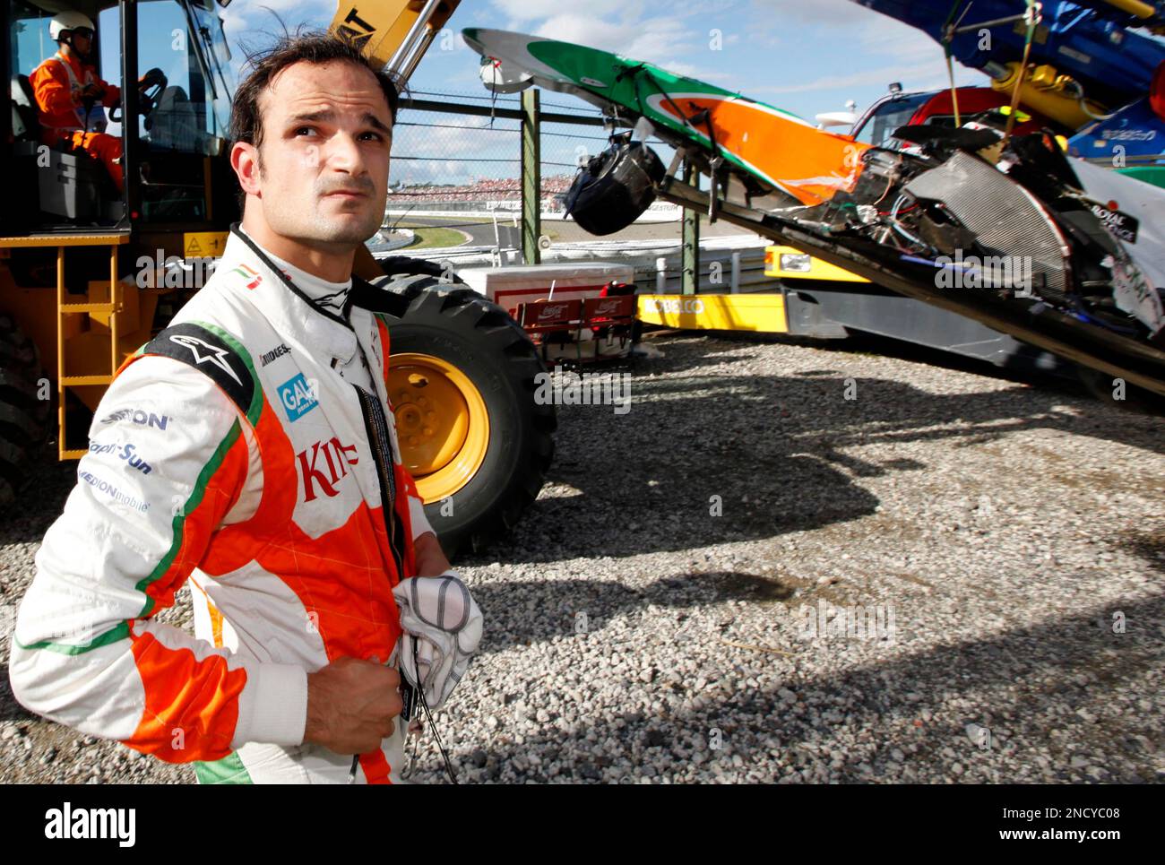 Force India Formula One driver Vitantonio Liuzzi of Italy walks past ...