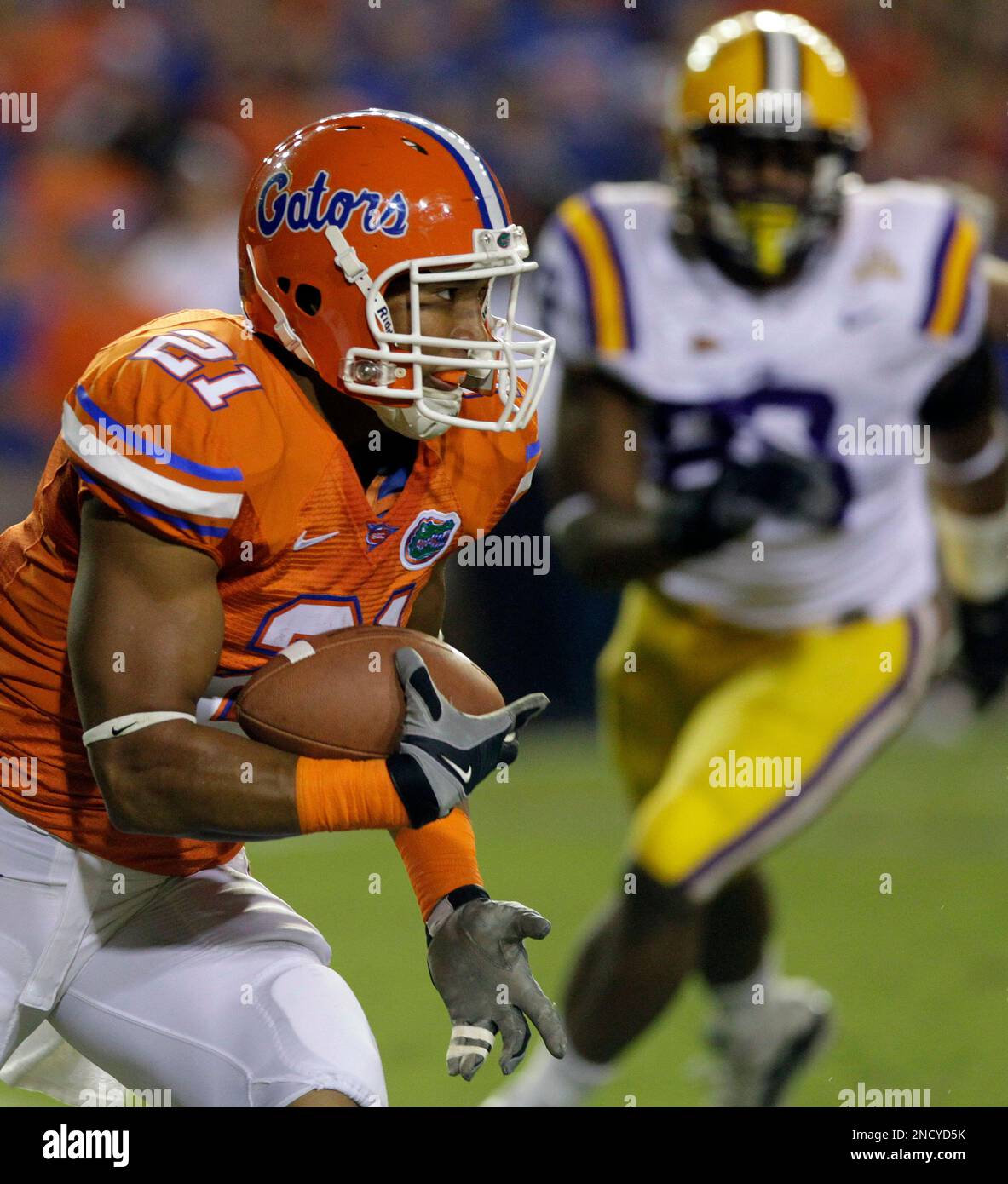 Florida running back Emmanuel Moody (21) runs for yardage as he tries to get past LSU tight end ...