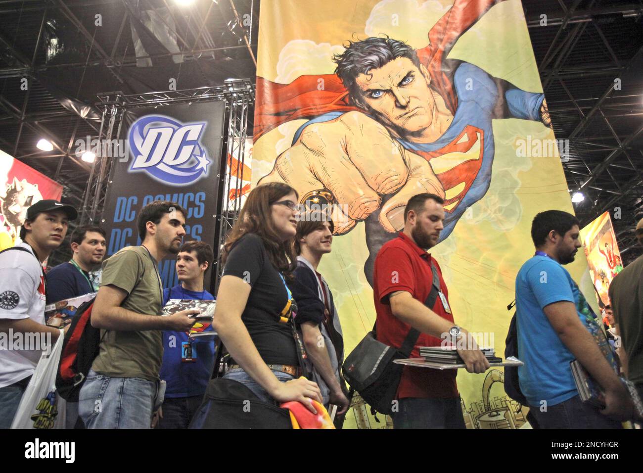 Comic book fans line up for autographs at the DC Comics booth during ...