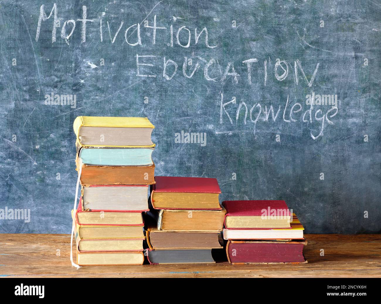 motivation,education,knowledge, books in front of blackboard,concept ...