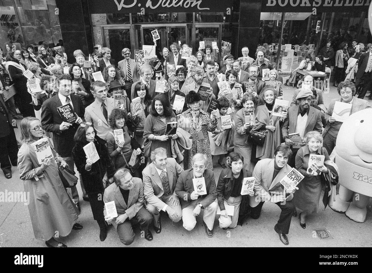 Some fifty authors hold up their books in front of a newly opened ...