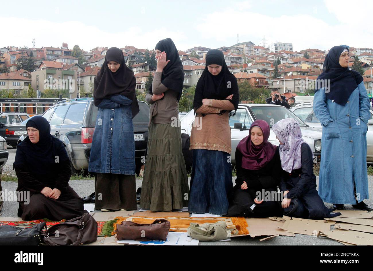 Kosovo Muslim women prepare to pray outside in a parking lot in the ...