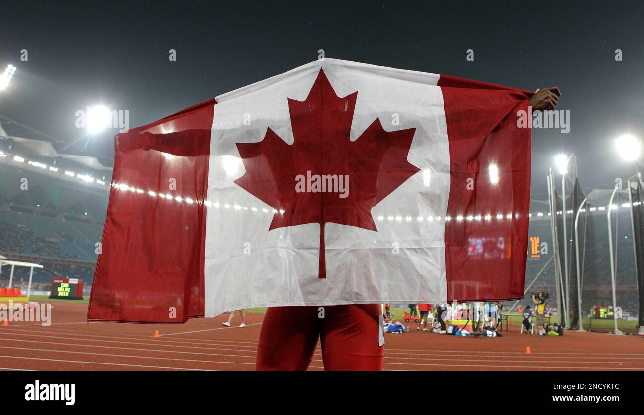 Canada's Jamie Adjetey-Nelson poses with the Canadian flag following ...