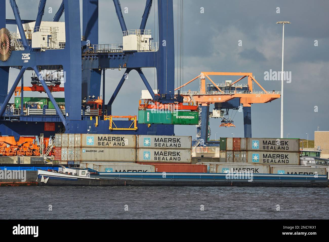 Loading containers on a ship Stock Photo - Alamy