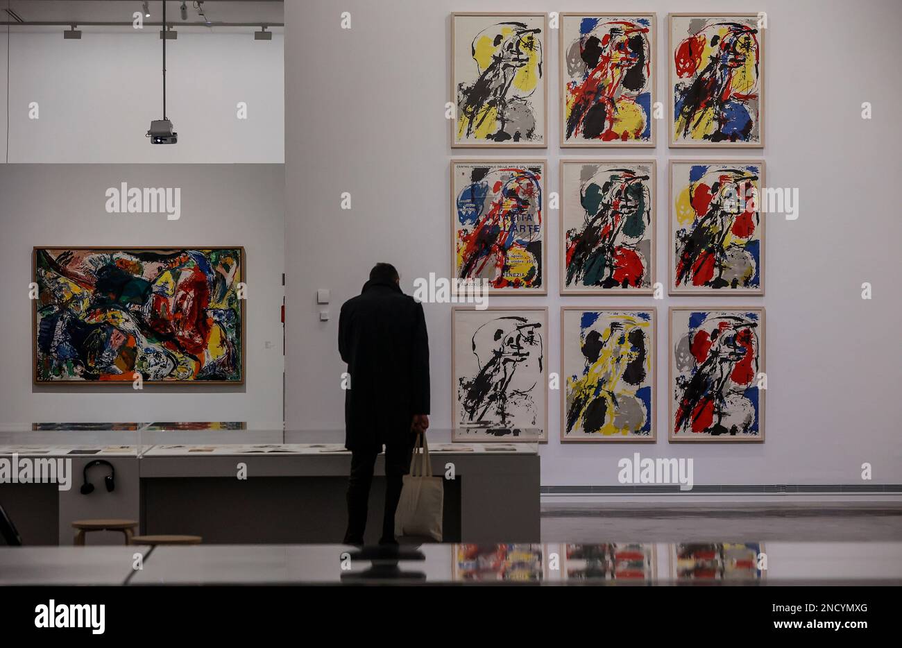 A man contemplates works from the exhibition 'Open Creation and its ...